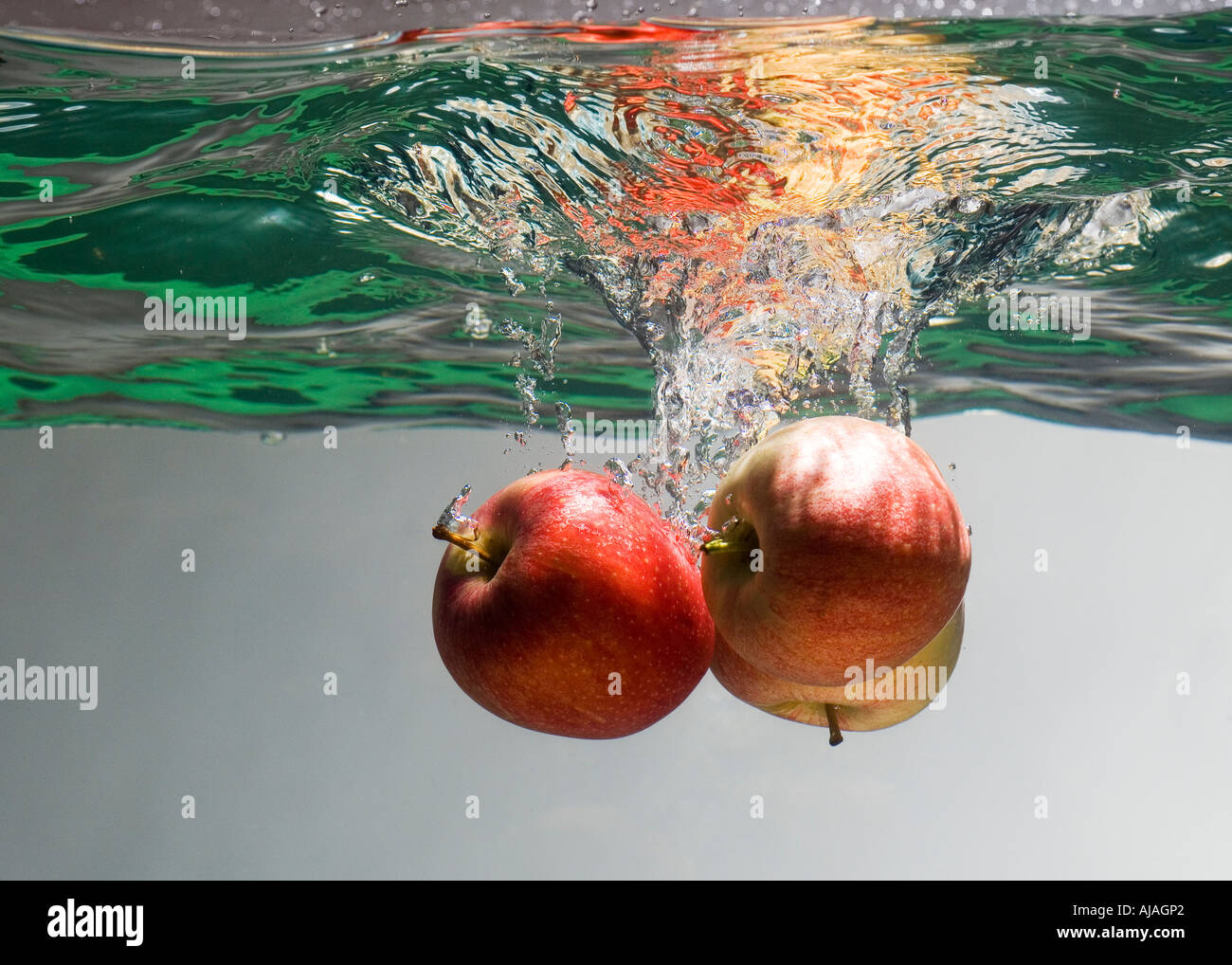 Apple´s falling into water Stock Photo - Alamy
