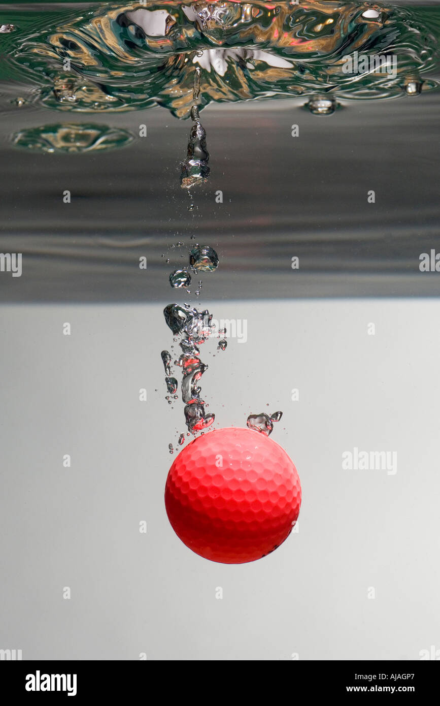 Golf ball falling into water Stock Photo - Alamy