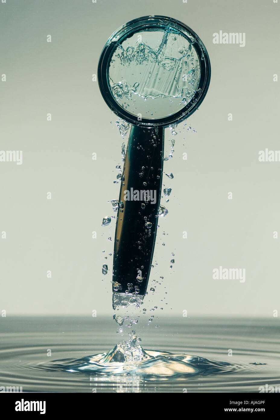 High speed photography of a Magnifying Glass falling into water Stock ...