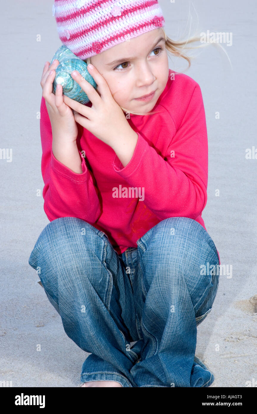 Young girl with a shell Stock Photo - Alamy