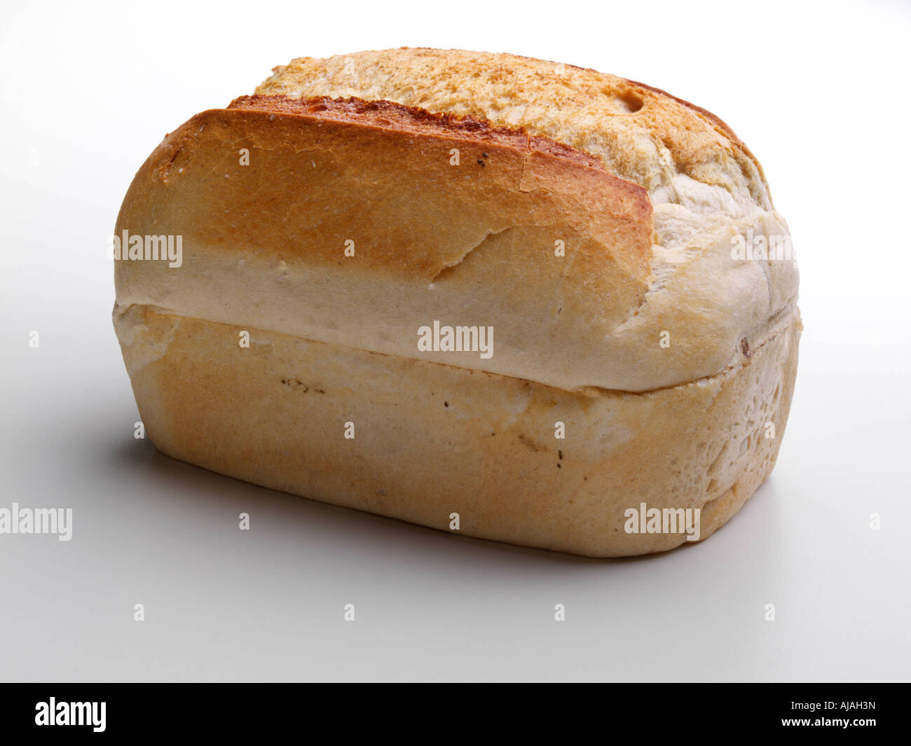 A whole farmhouse loaf on a white background Stock Photo - Alamy