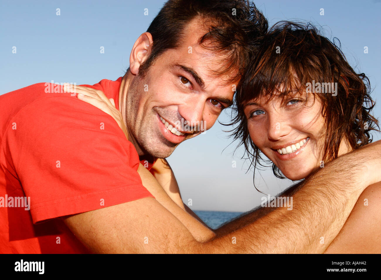 Fun and Colorful Couple Embracing Stock Photo - Alamy