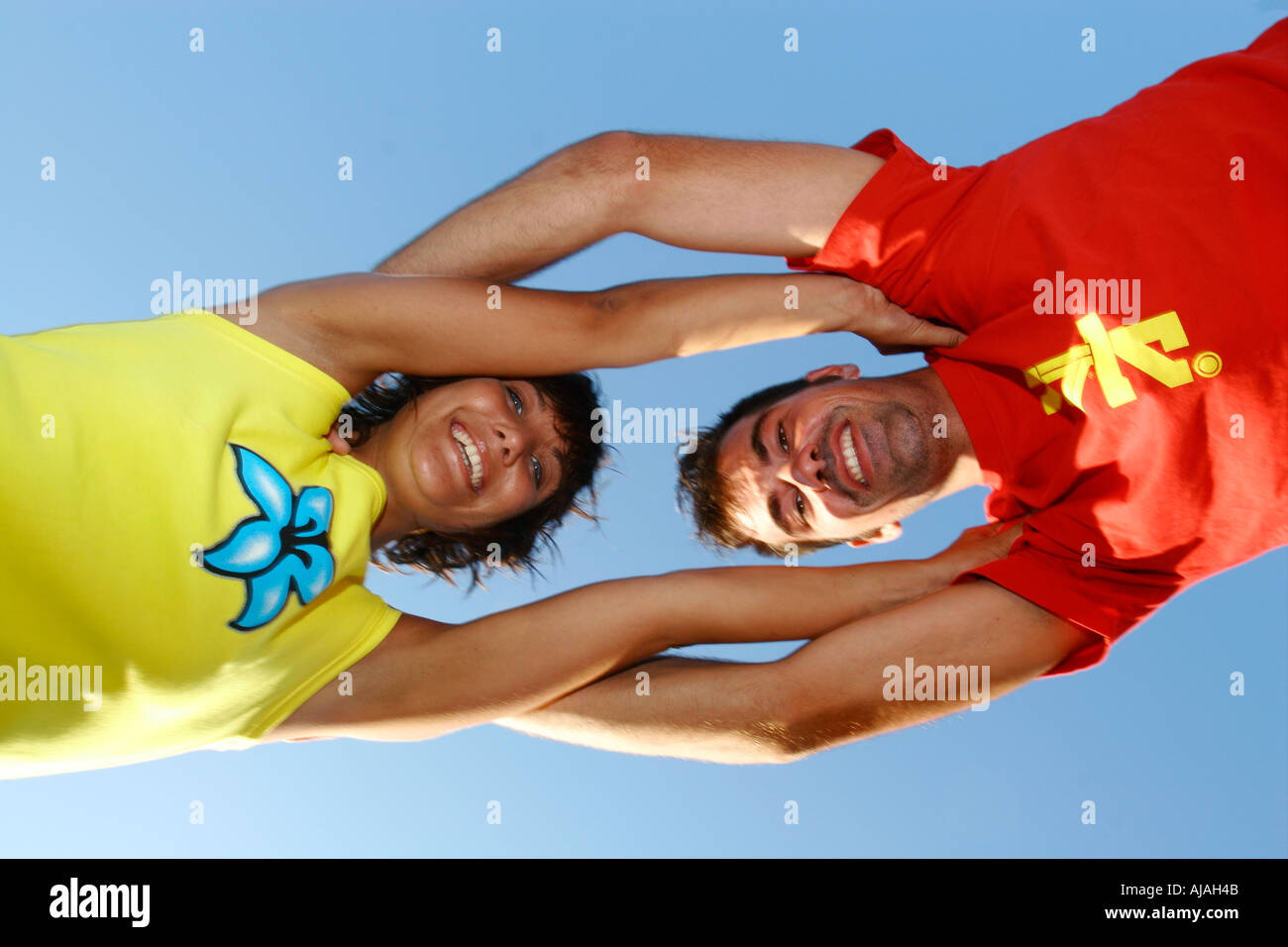 Couple looking down at camera Stock Photo - Alamy