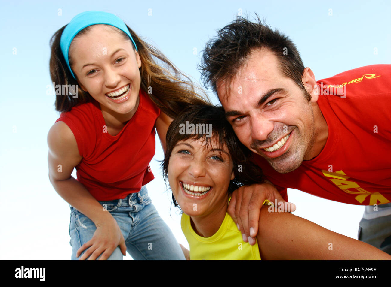 Fun trio in colourful casual clothes underneath the sky Stock Photo - Alamy