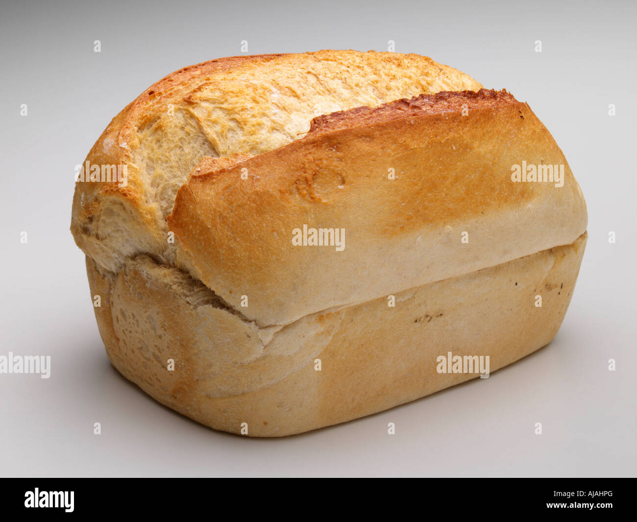 A whole farmhouse loaf on a white background Stock Photo - Alamy
