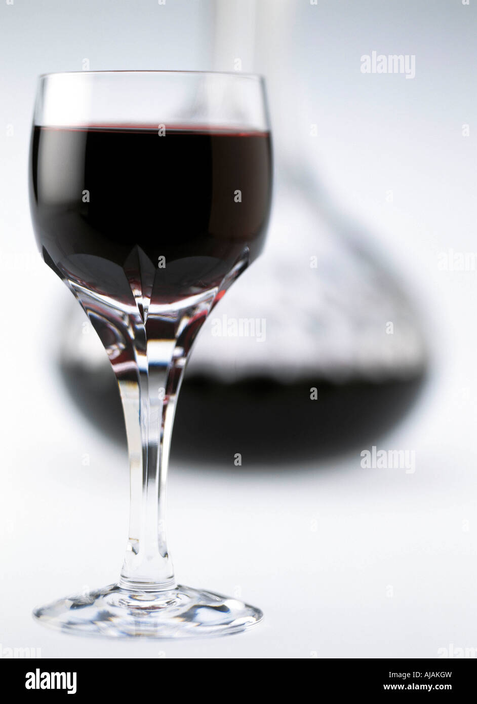 A glass of port with a decanter in the background Stock Photo - Alamy