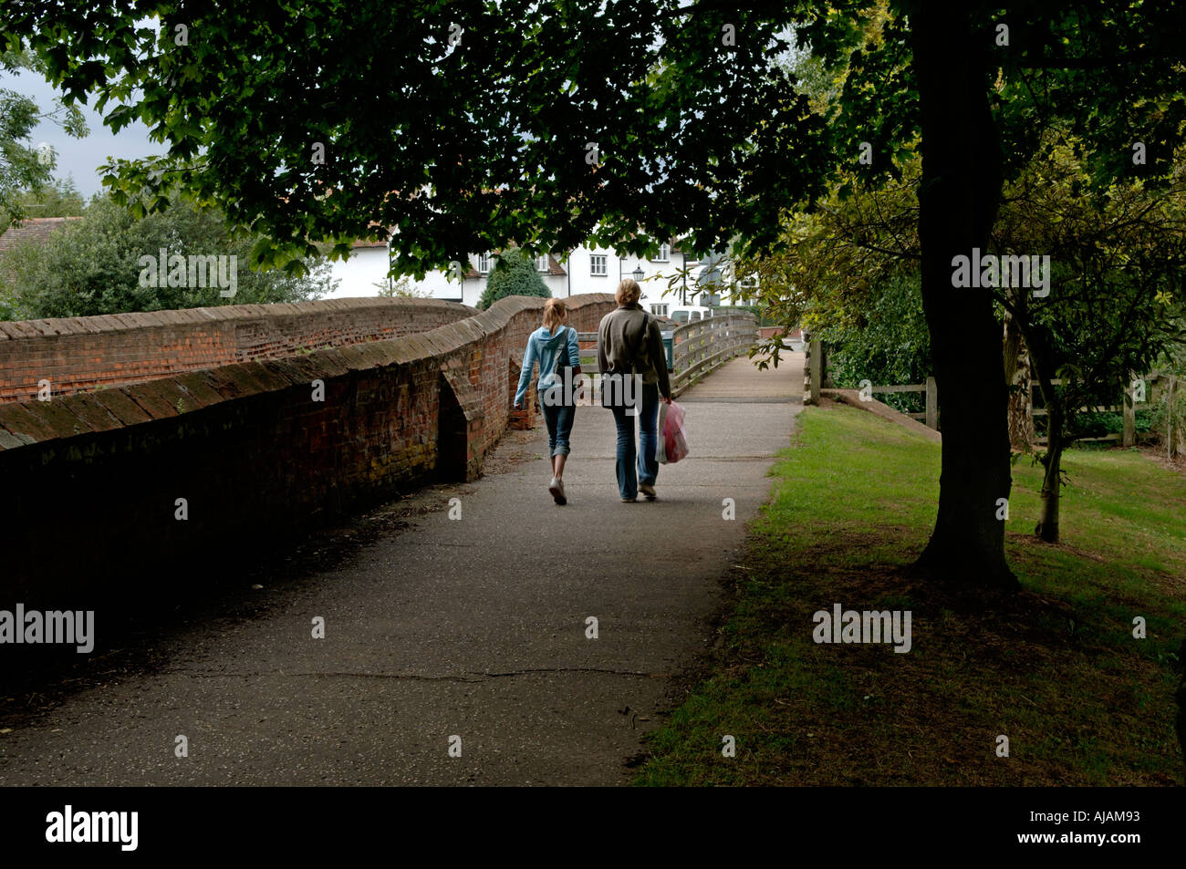 Two people walking on a secluded suburban footpath Stock Photo - Alamy