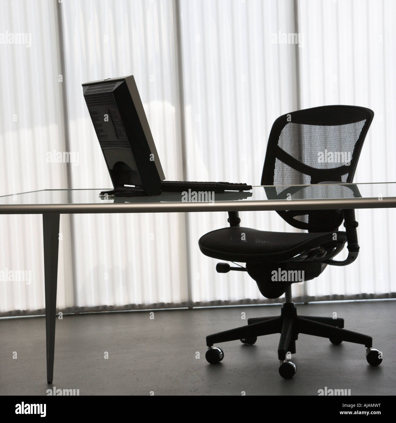 Empty office with desk and laptop computer and chair Stock Photo - Alamy