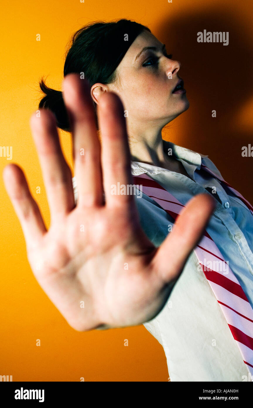Stop! Young woman holding arm outstretched to stop any approach Stock ...