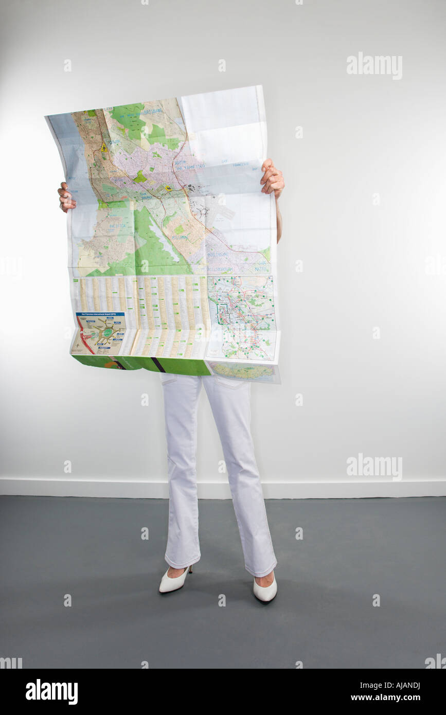 Full length portrait of Caucasian woman holding map Stock Photo - Alamy
