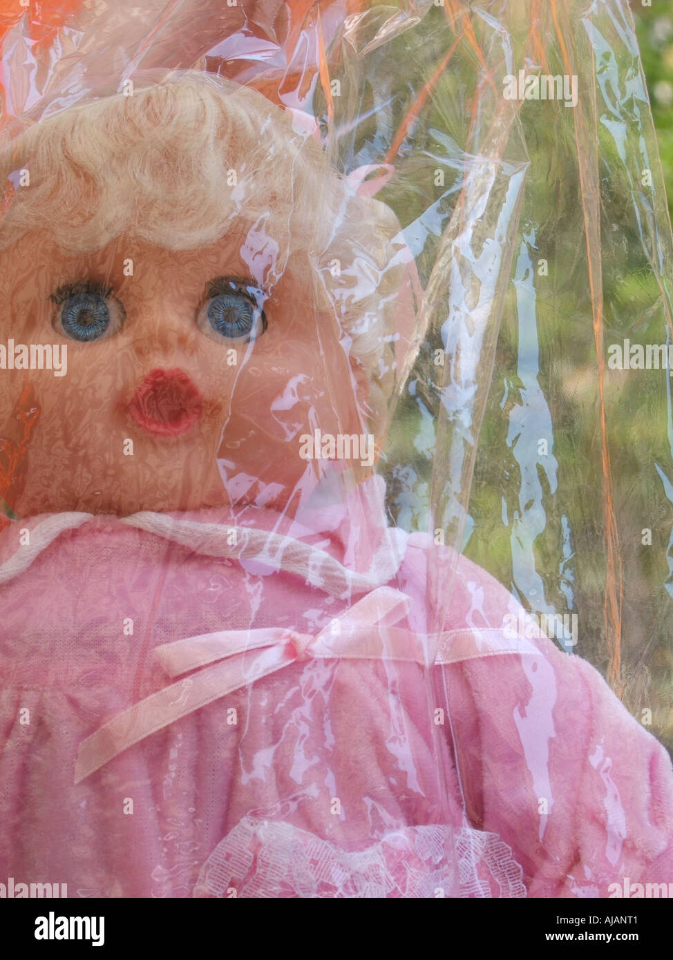 blond baby doll girl in cellophane wrapping Stock Photo - Alamy