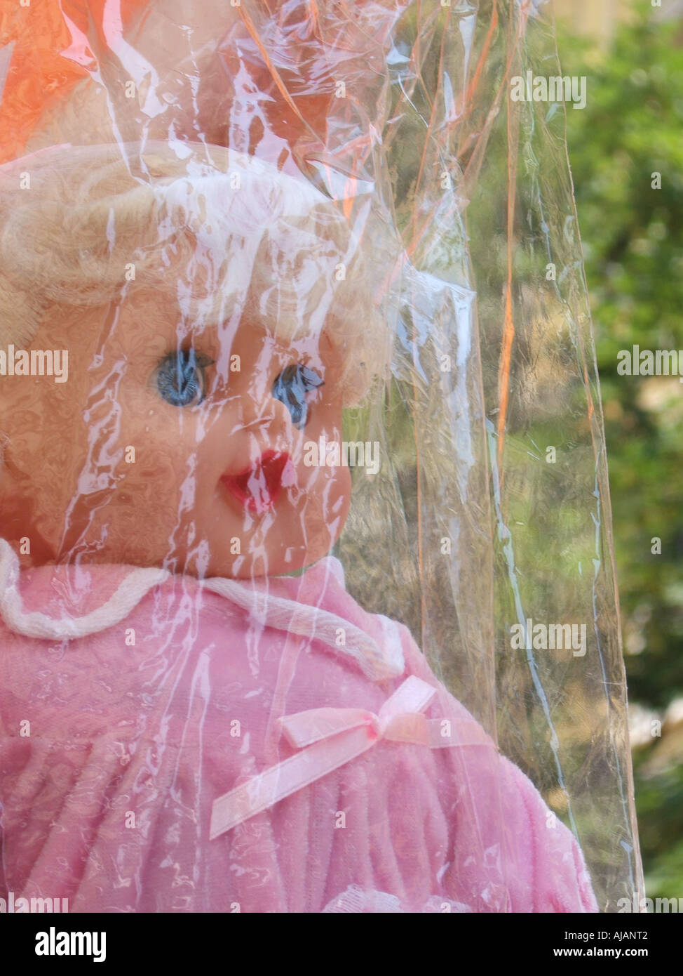 blond baby doll girl in cellophane wrapping Stock Photo - Alamy