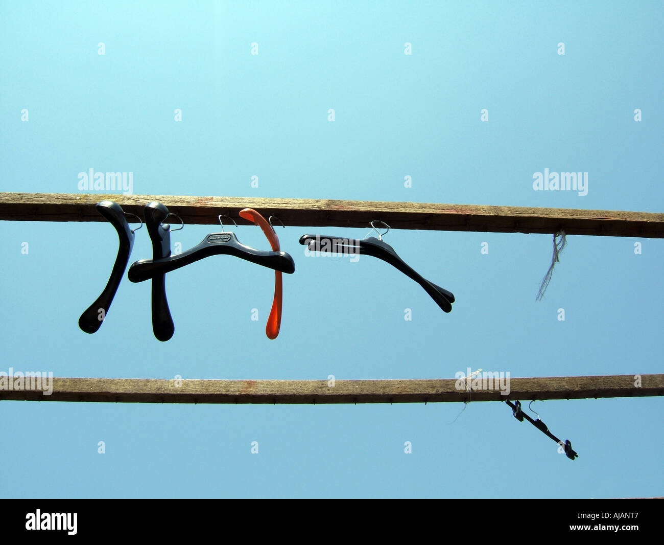 clothes hangers on closing market stall Stock Photo - Alamy
