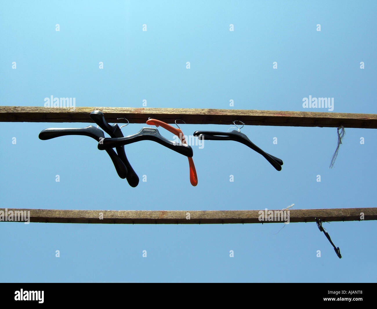 clothes hangers on closing market stall Stock Photo - Alamy