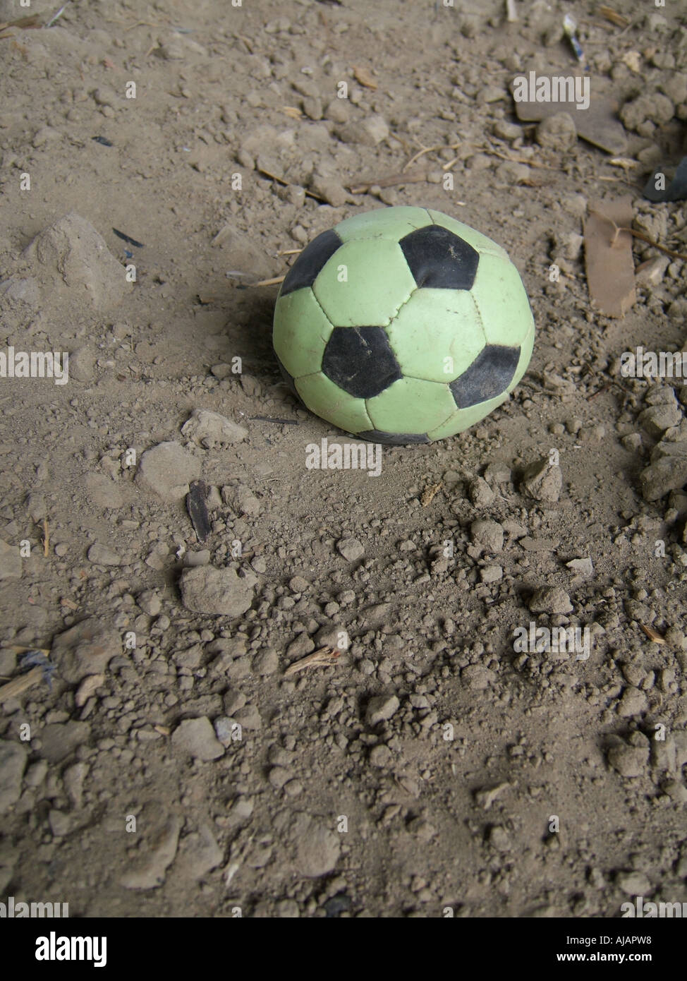 one dirty football on derelict ground Stock Photo - Alamy