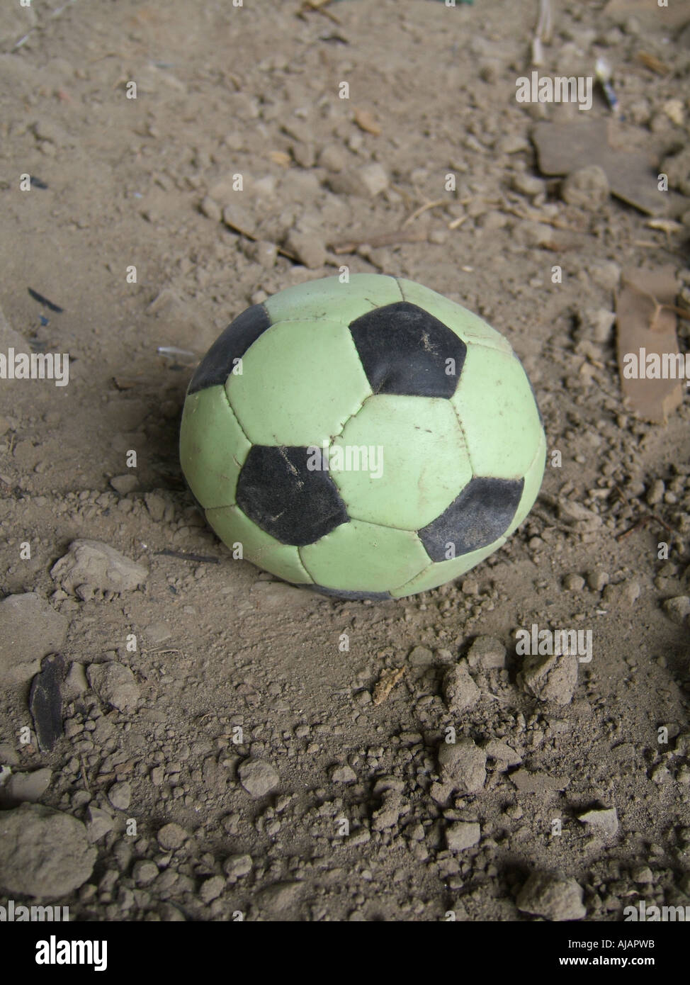 one dirty football on derelict ground Stock Photo - Alamy