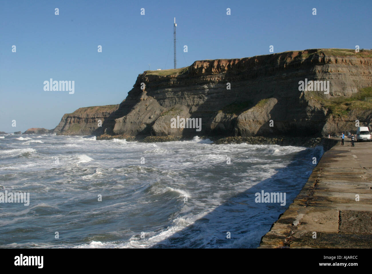 Two boys fishing on pier and Waves Whitby East Yorkshire Stock Photo ...