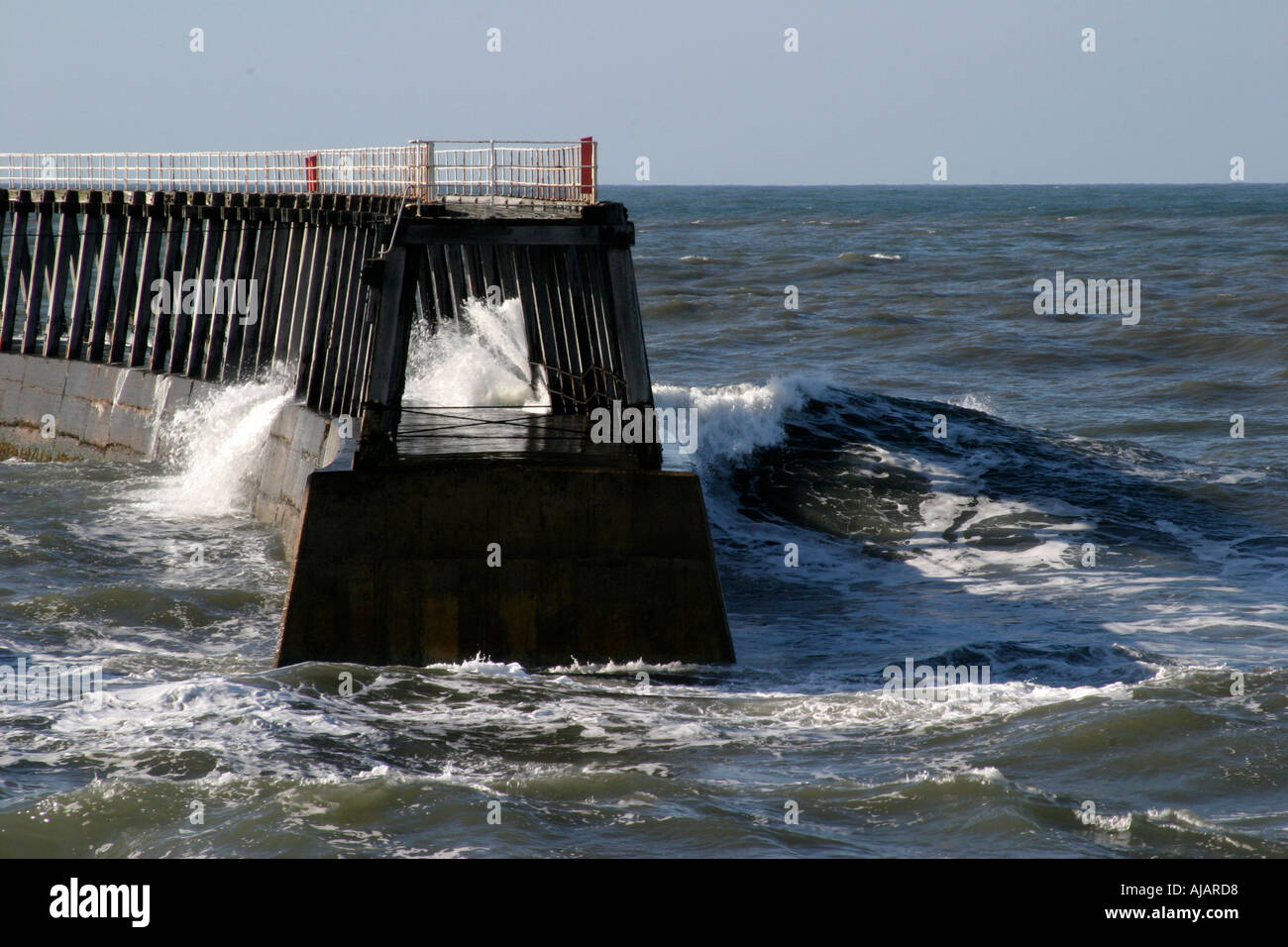 Sequence of waves crashing through a pier at Whitby East Yorkshire ...
