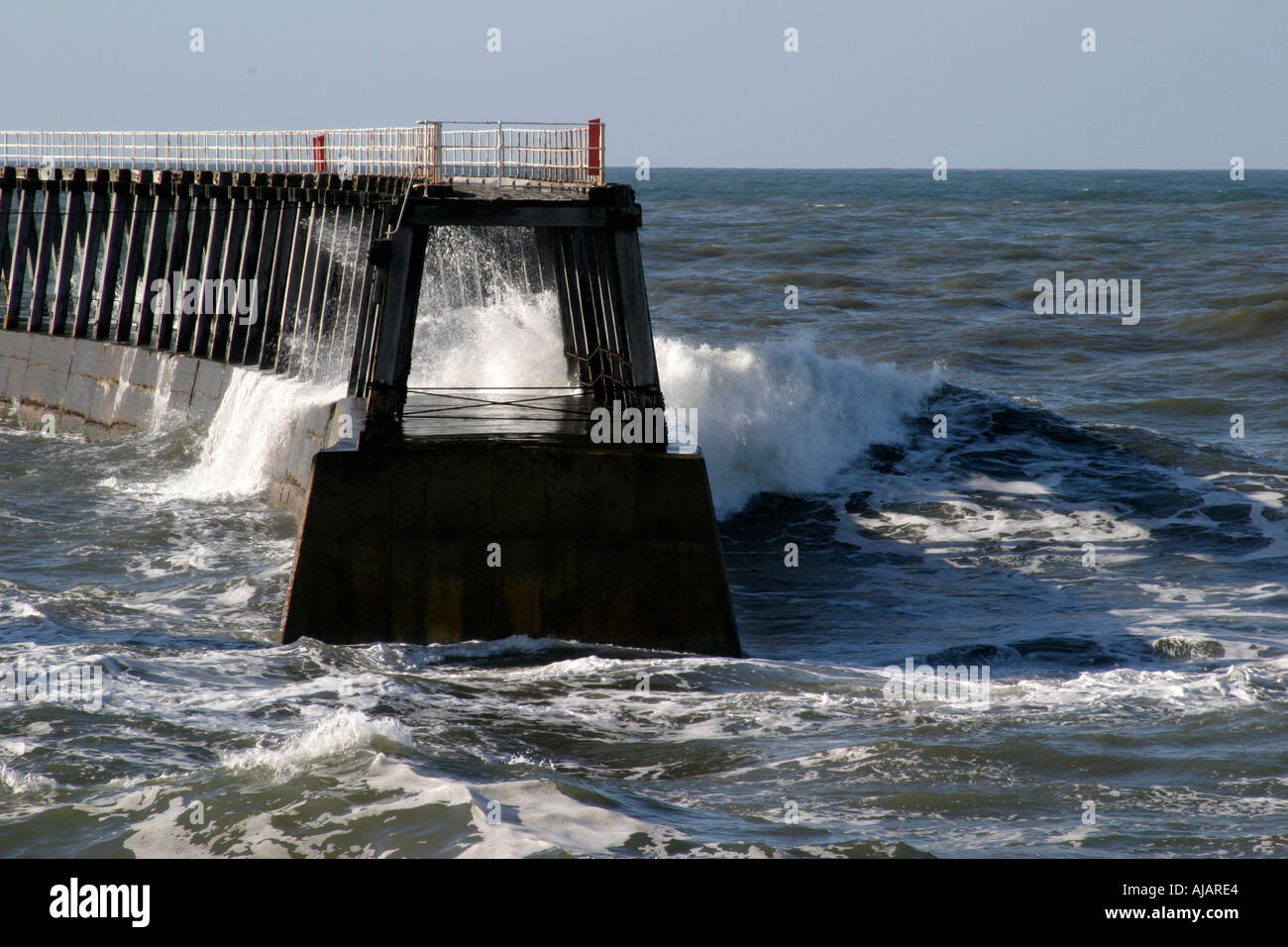 Sequence of waves crashing through a pier at Whitby East Yorkshire ...
