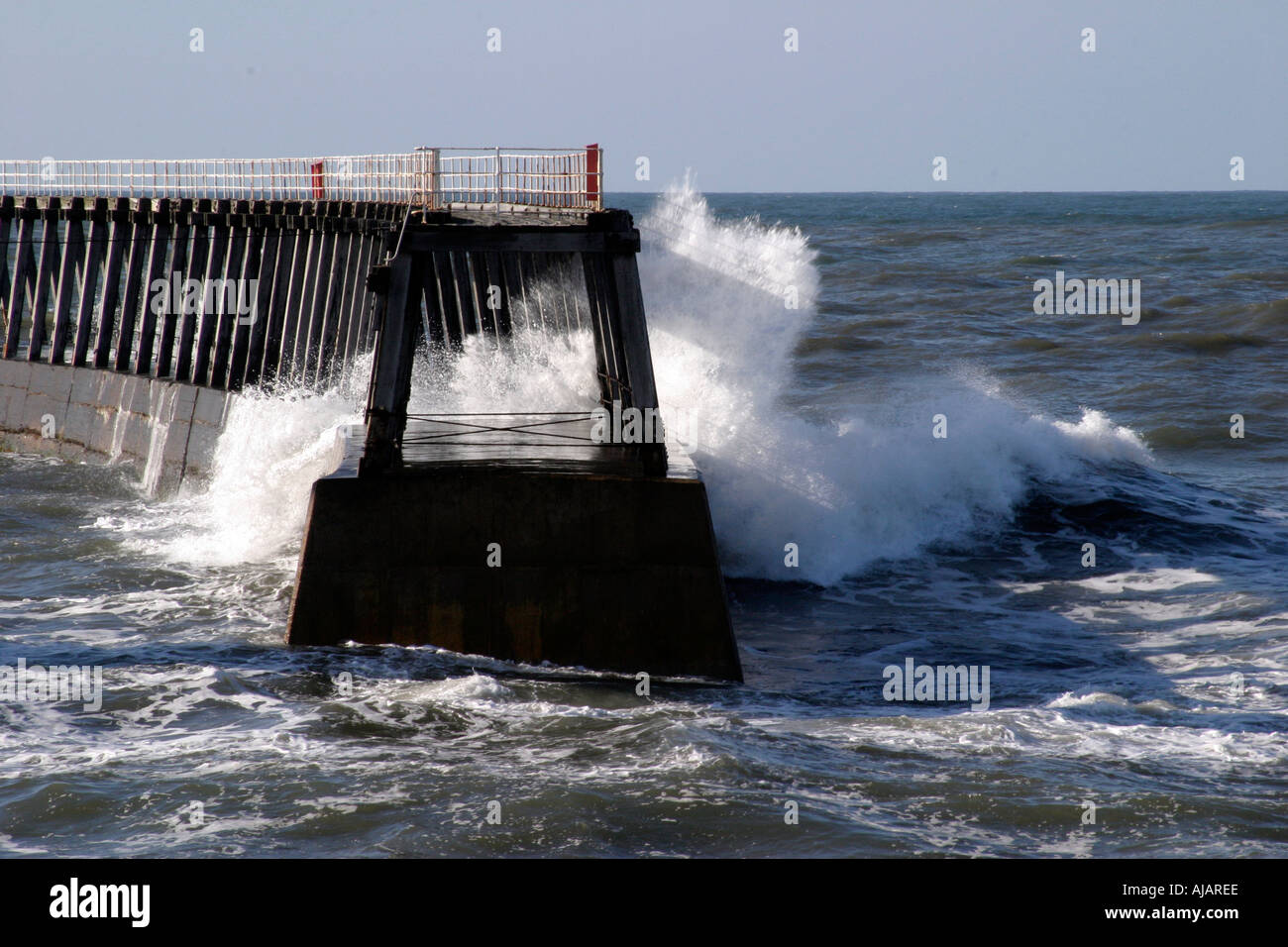 Sequence of waves crashing through a pier at Whitby East Yorkshire ...