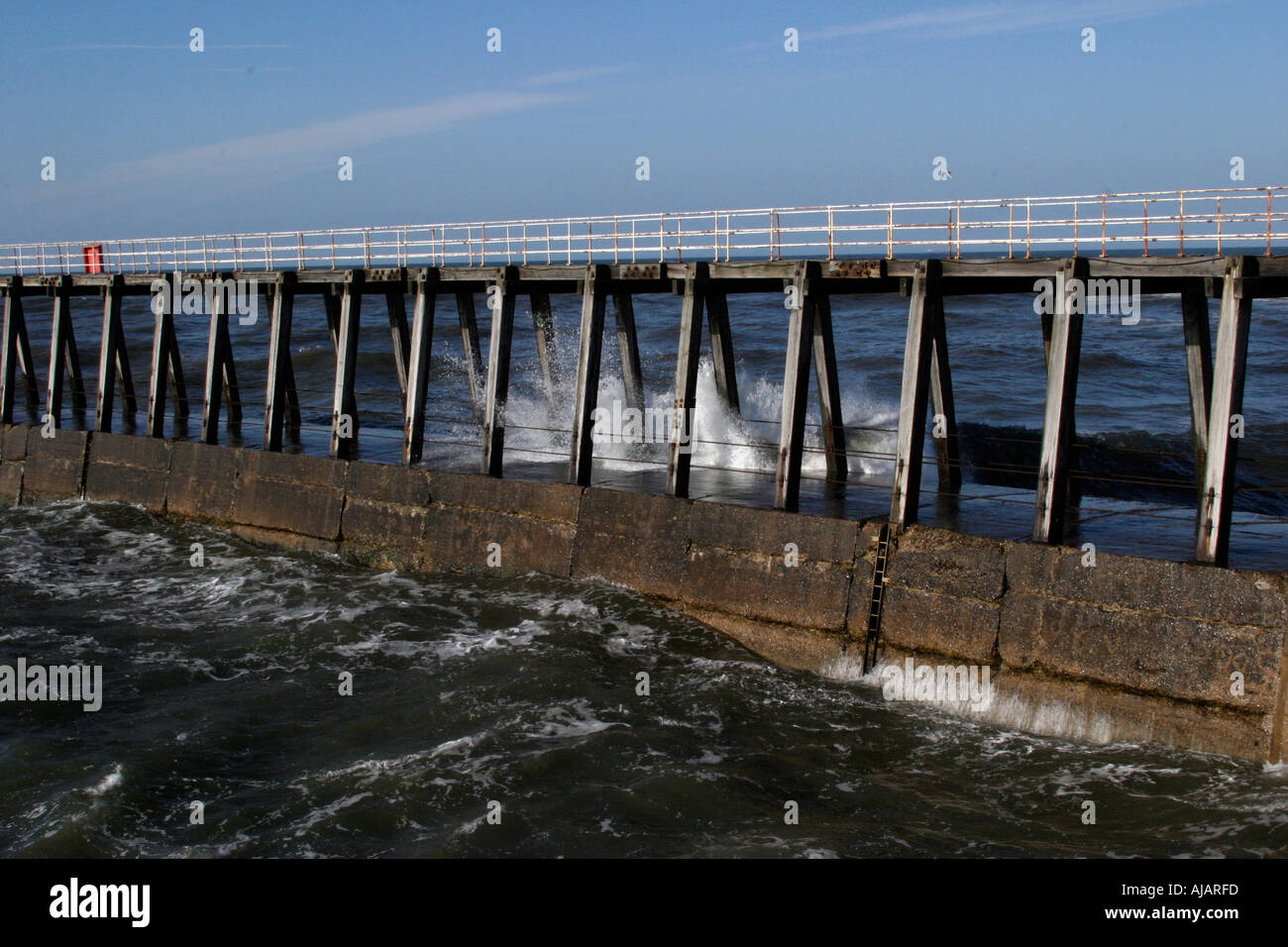 Sequence of waves crashing through a pier at Whitby East Yorkshire ...