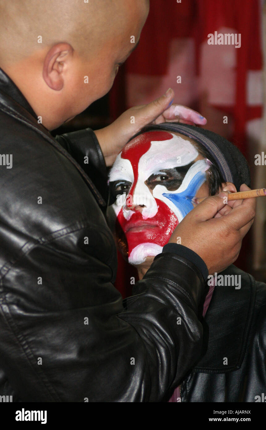 Actor s face being painted in the traditional Chinese mask colors by ...