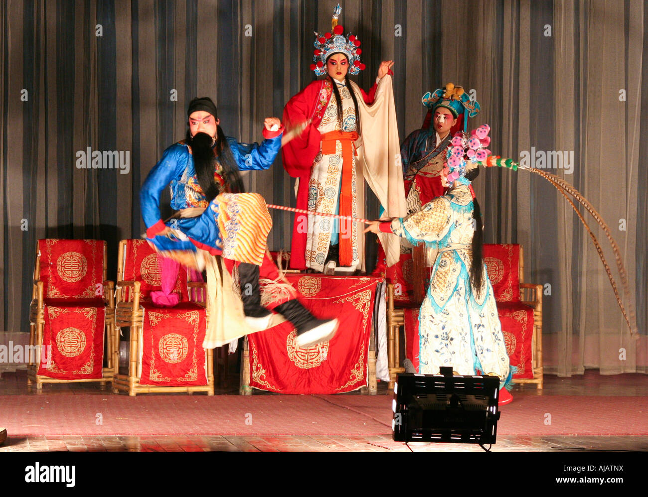 Actors of the Chengdu Opera dressed in traditional clothing performing ...