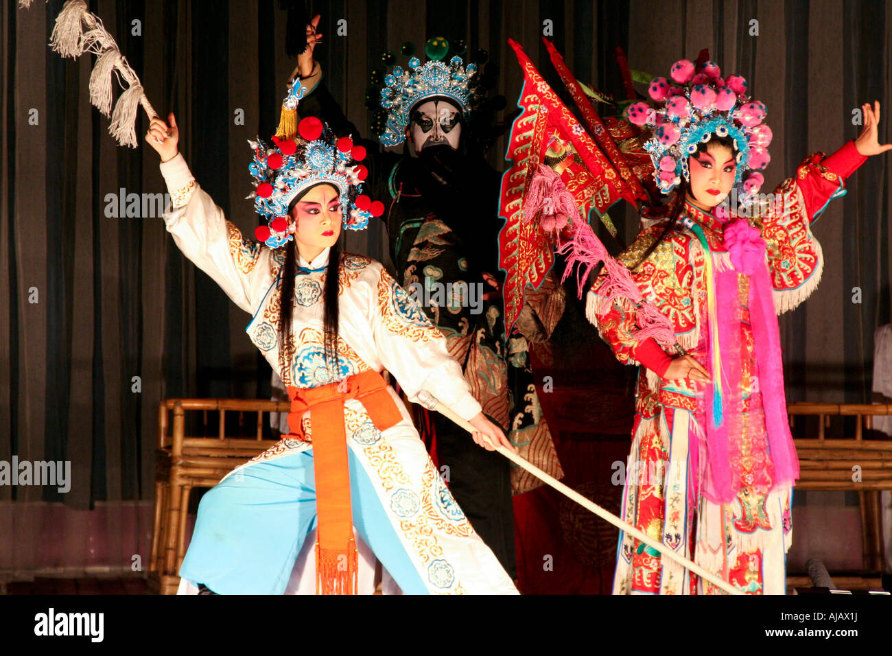 Actors of the Chengdu Opera dressed in traditional clothing performing ...