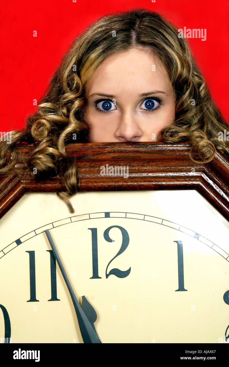 Young Woman Looking Over A Clock With Look of Shock Concept Photo Stock ...