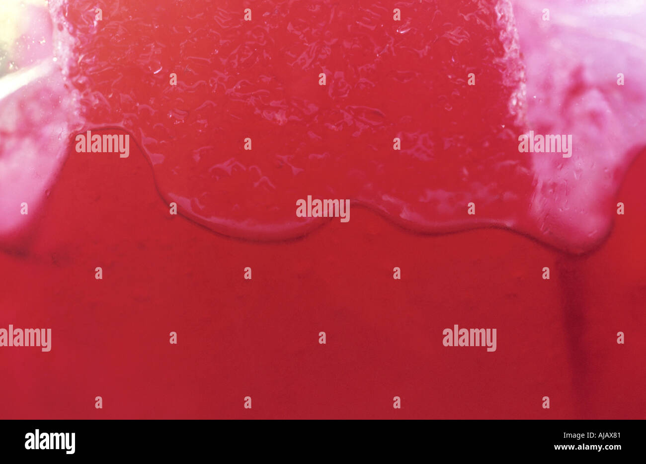Melting ice with coloured red water Stock Photo - Alamy