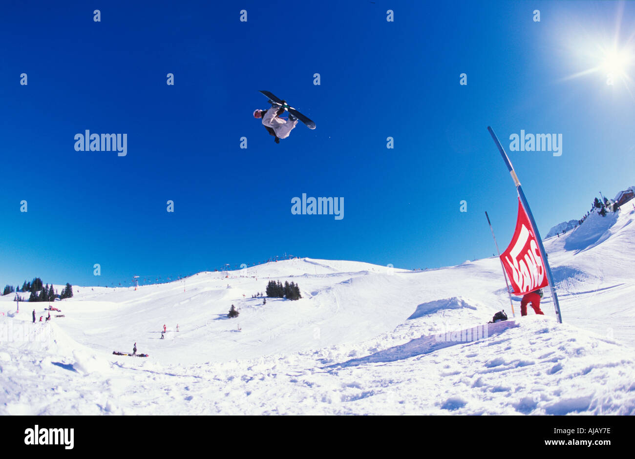 Female snowboarder jumping in snowboard park Wide angle action Stock ...