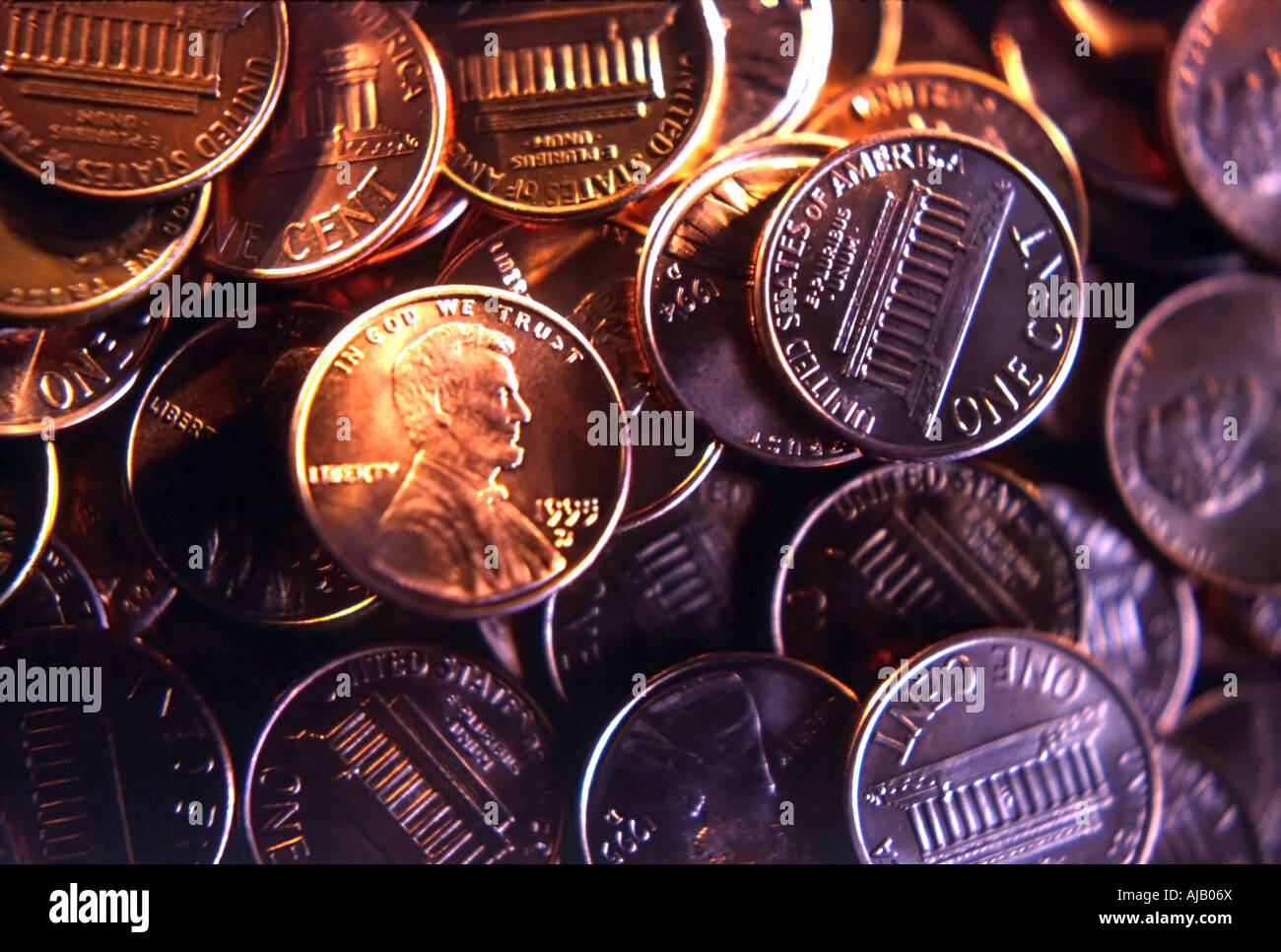 A background of common american copper pennies. One is highlighted ...