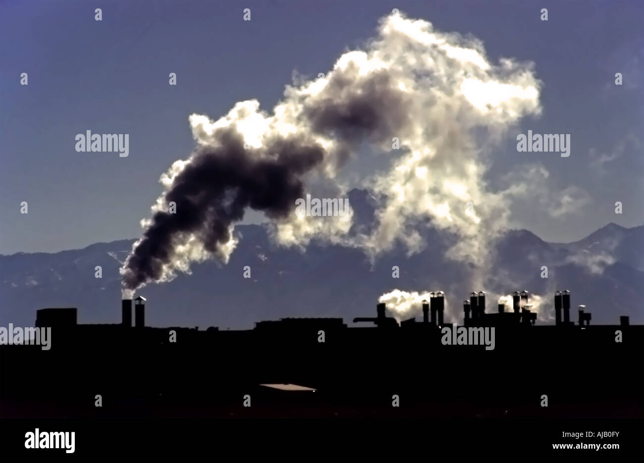 A dramatically backlit image of an american processing plant. The ...