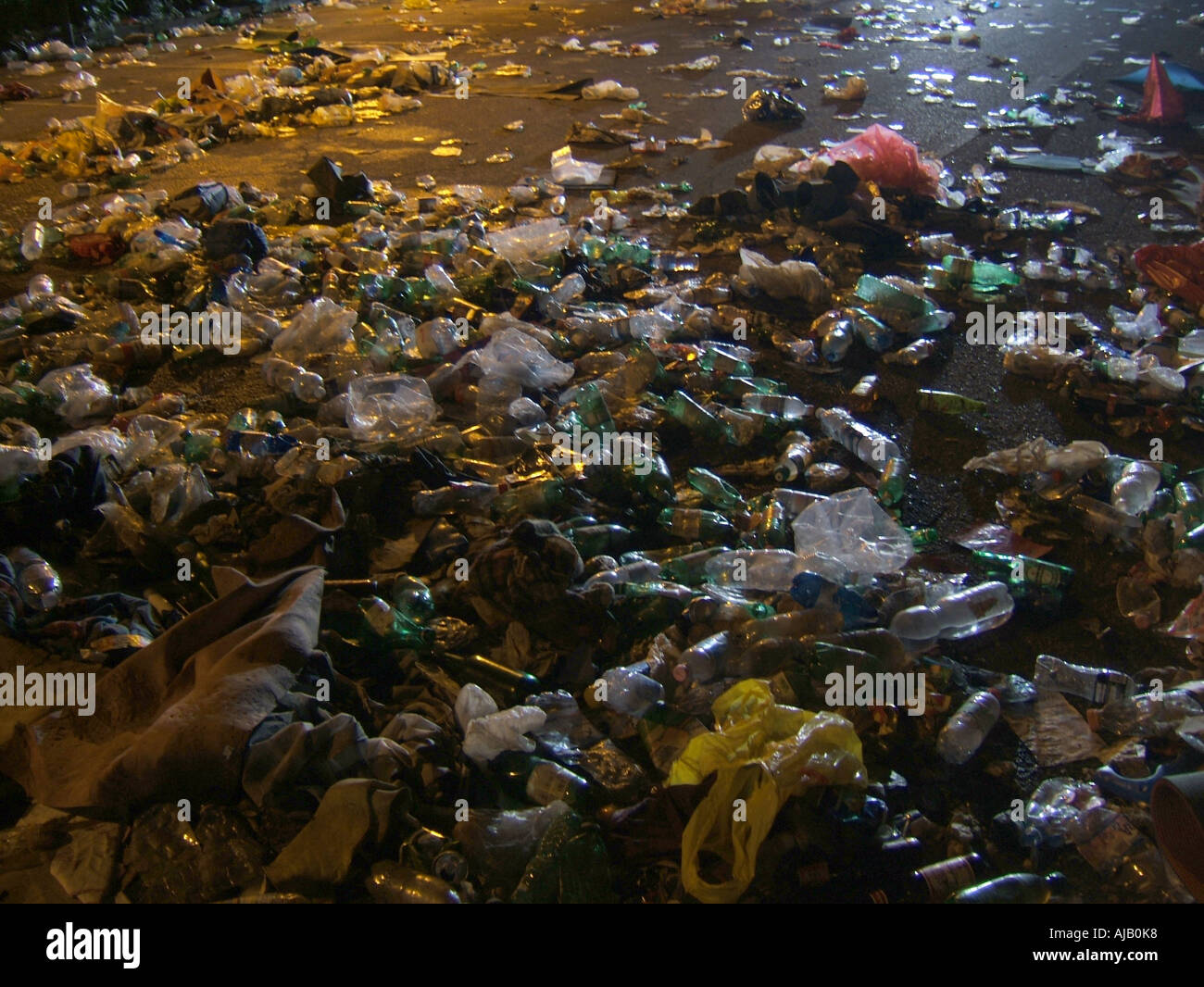 a lot of rubbish thrown out causing pollution in street at night Stock ...