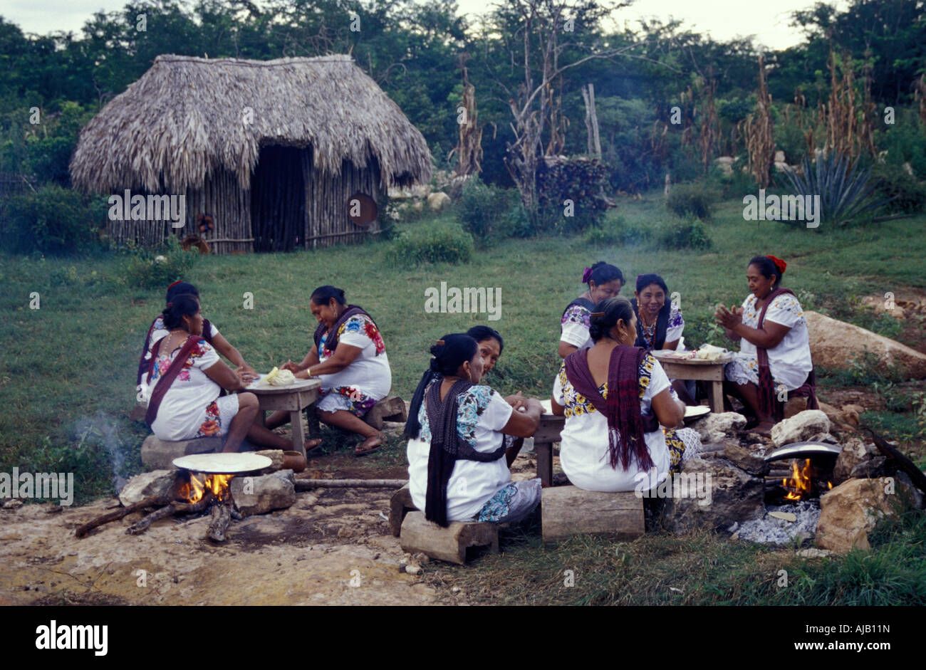 Maya women cooking tortillas over open fires with a traditional Mayan ...