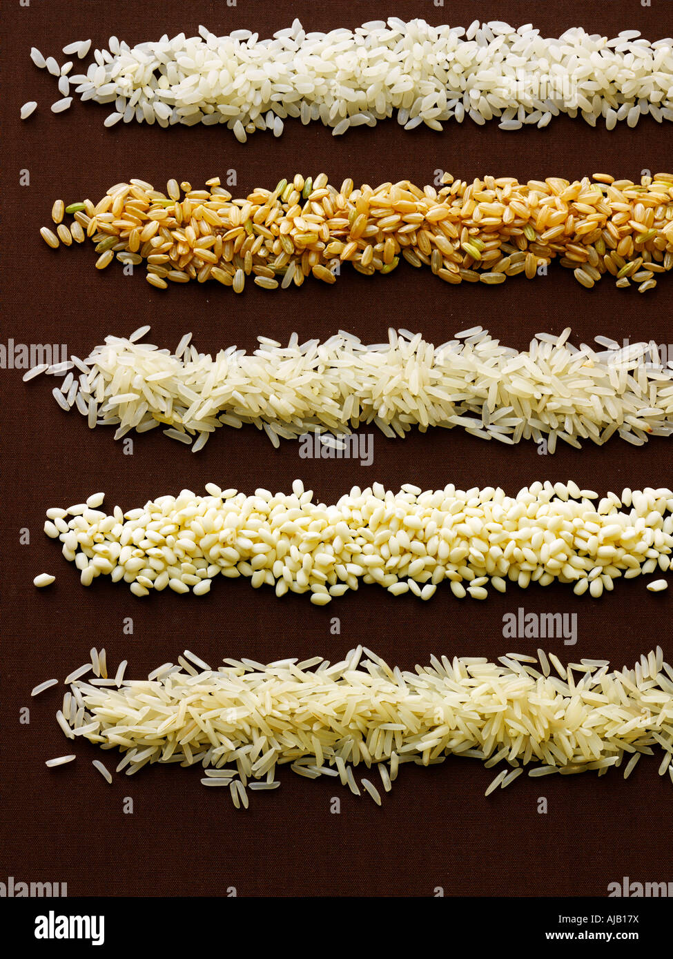 Various Rice Grains on Brown background Stock Photo - Alamy