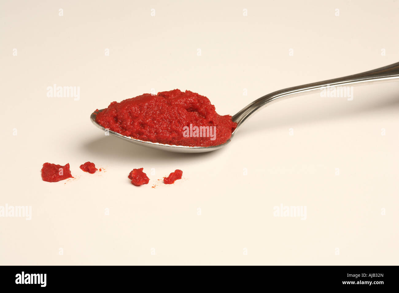 A cutout shot of a spoonful of tomato puree Stock Photo - Alamy