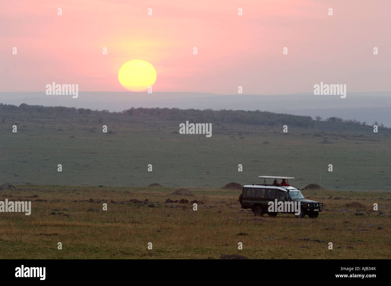 Sunrise in the Masaii Mara Kenya with game spotting vehicle Stock Photo ...