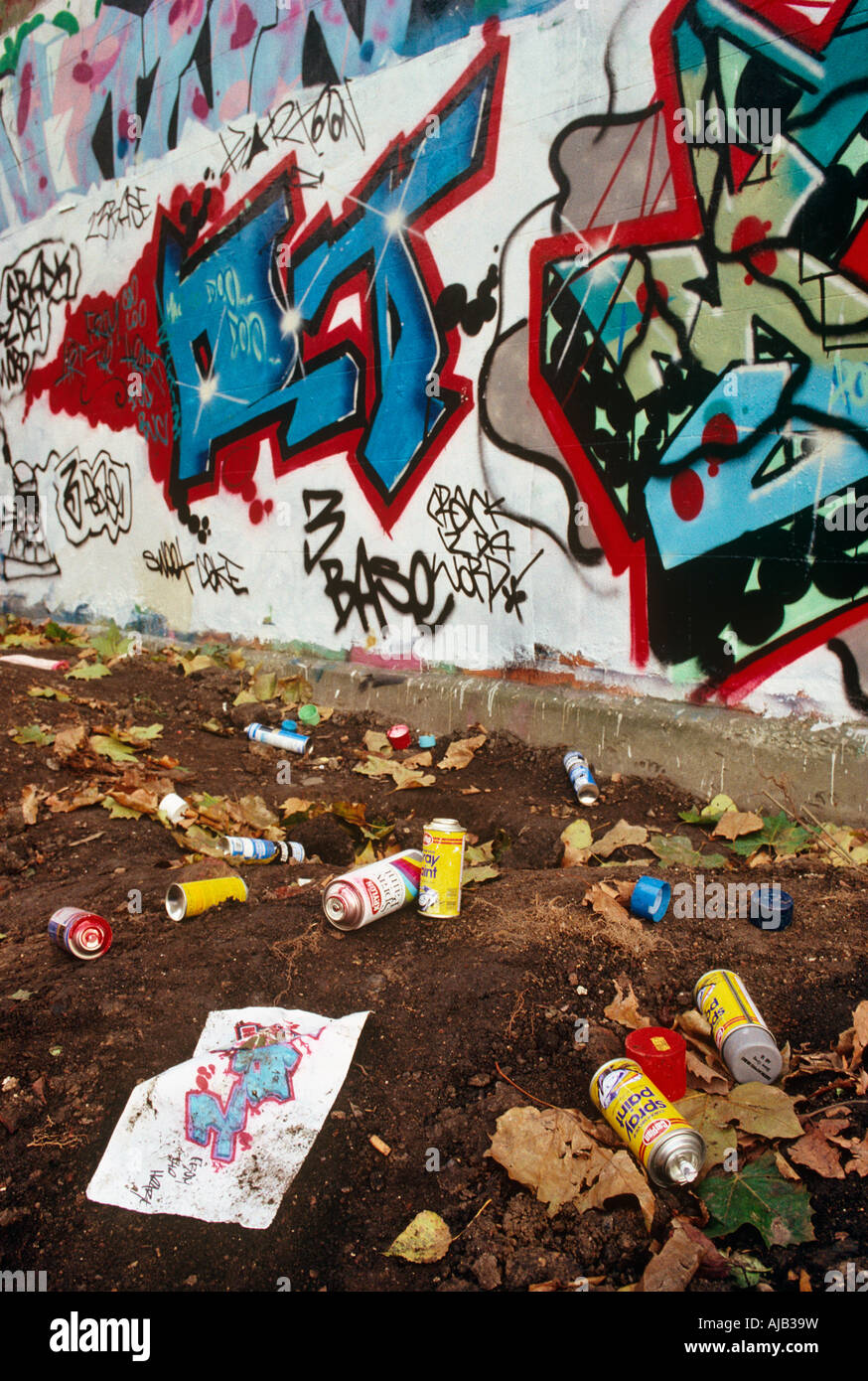 Abandoned aerosol spray cans lie in soil after a graffiti gang's ...
