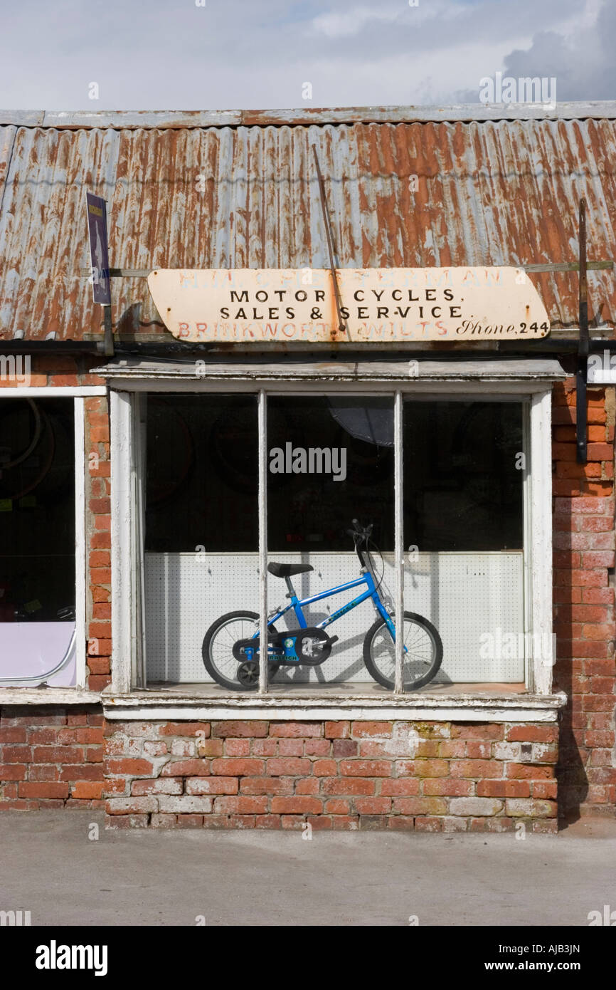 Brand new bicycles on show in neglected shop window of bike shop ...