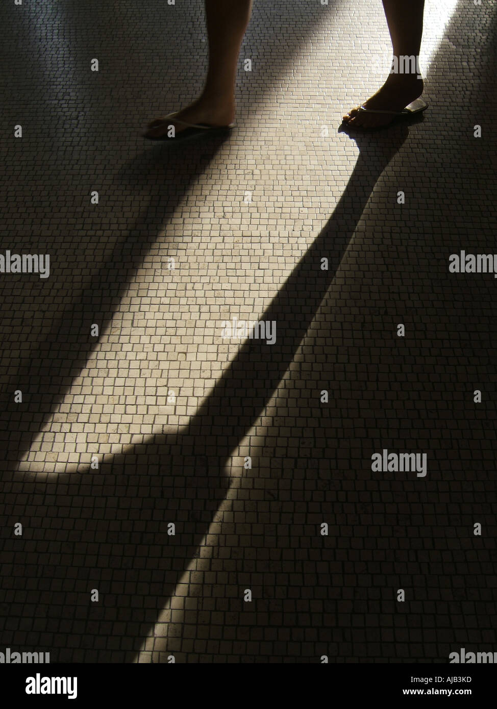 person walking through beam of light Stock Photo - Alamy
