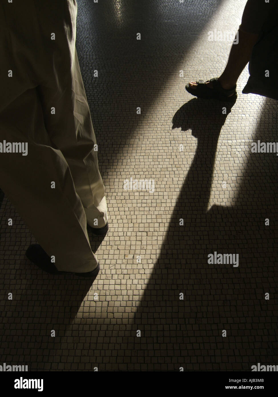 person walking through beam of light Stock Photo - Alamy