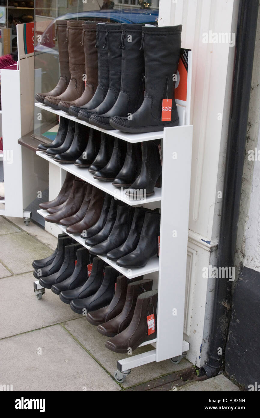 Shoe shop display rack of black leather boots and shoes Stock Photo - Alamy