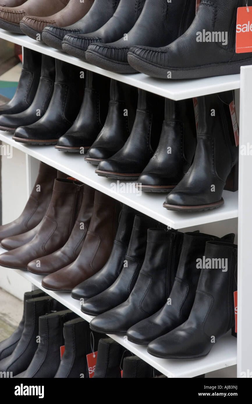 Shoe shop display rack of black leather boots and shoes Stock Photo - Alamy