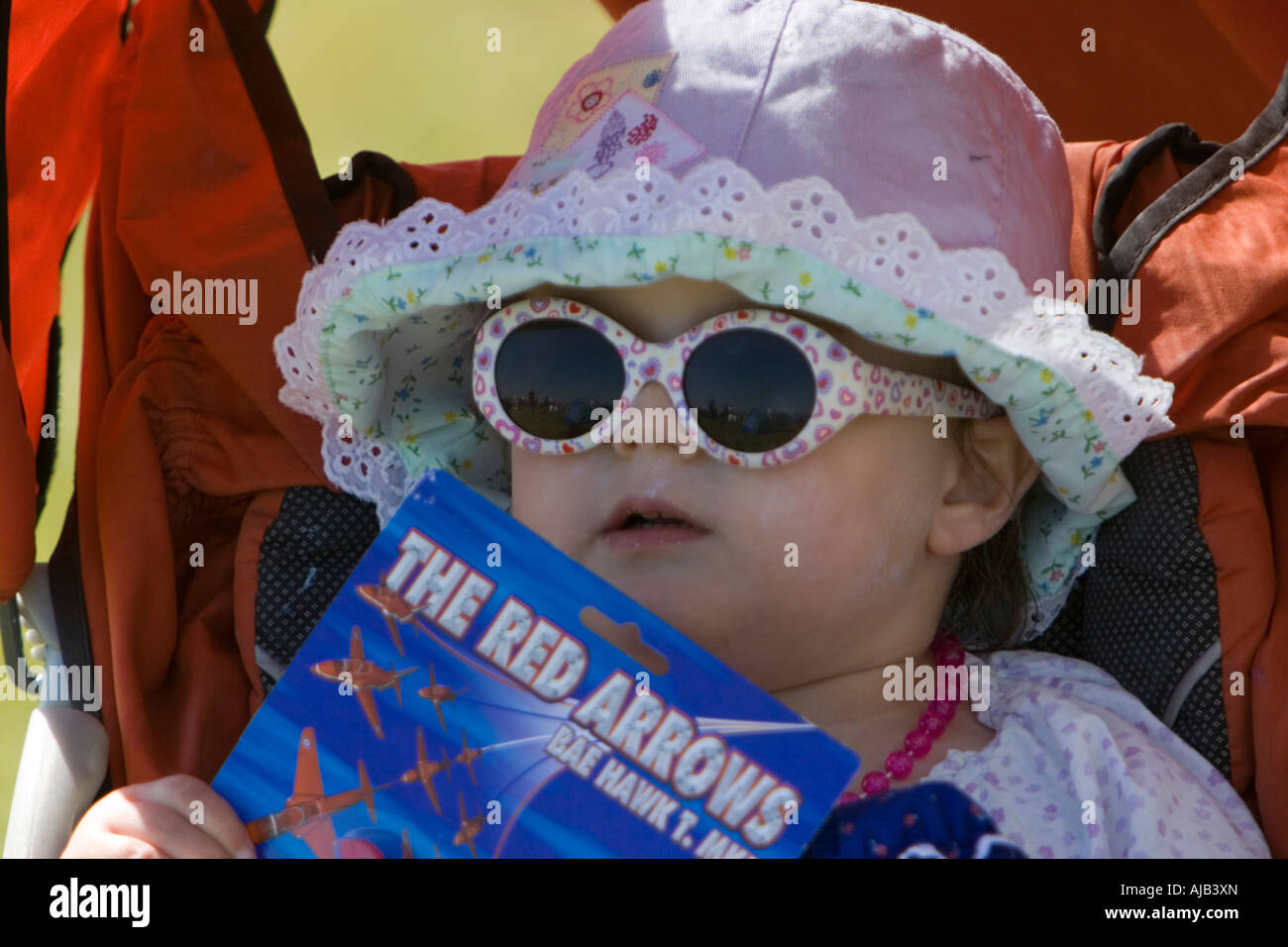 Young fan of the Red Arrows watching them at an airshow Stock Photo - Alamy