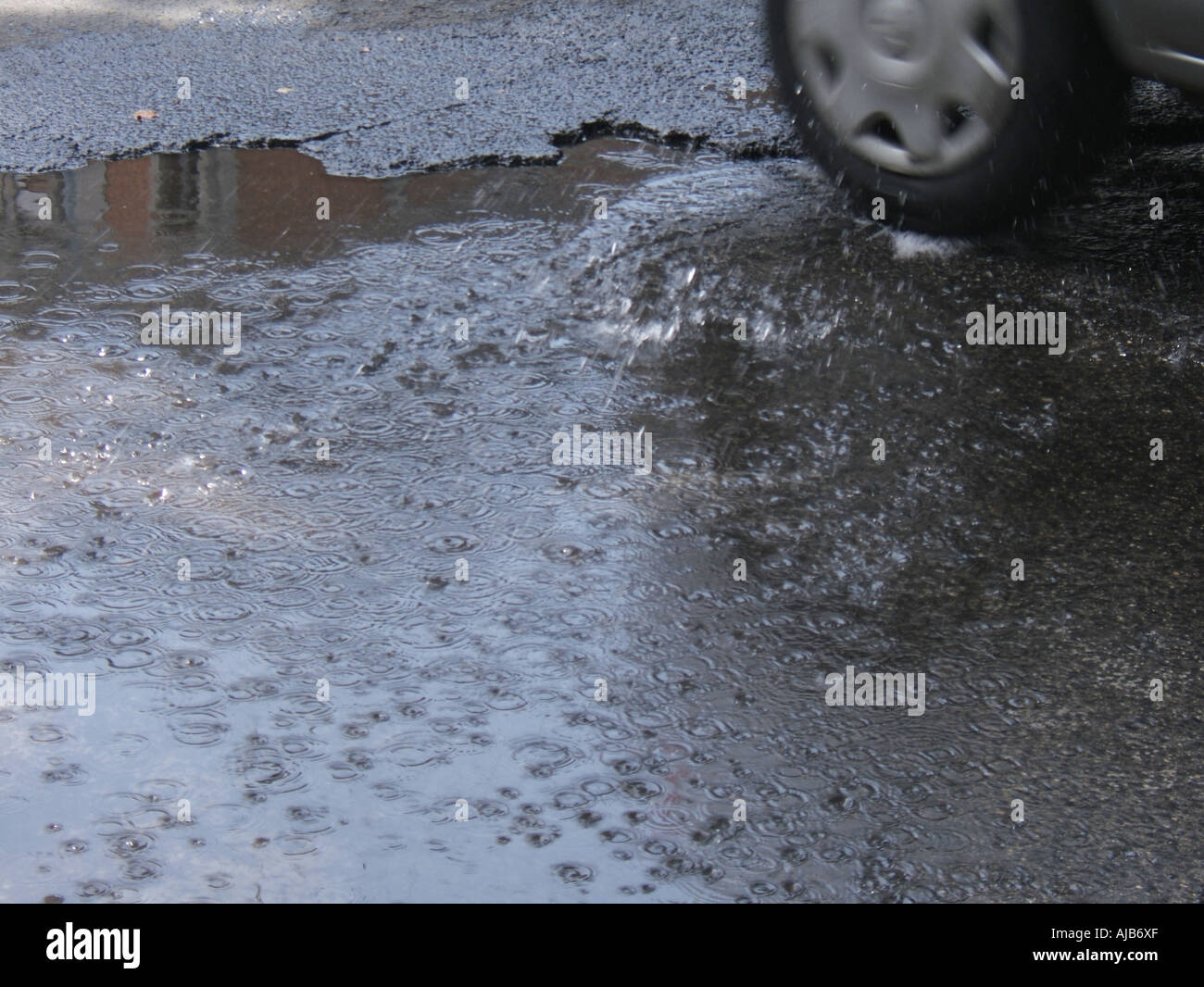 Car moving through flooded street hi-res stock photography and images ...