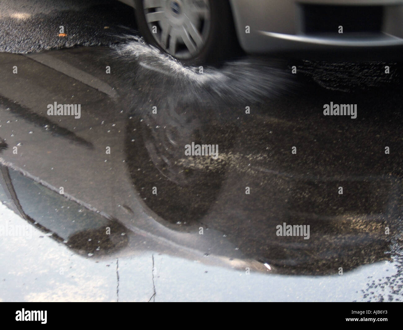car driving through a pool of water on street Stock Photo - Alamy