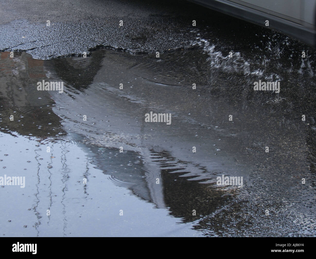 car driving through a pool of water on street Stock Photo - Alamy