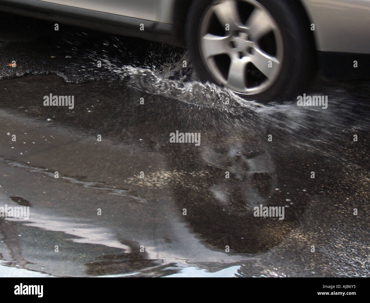 car driving through a pool of water on street Stock Photo - Alamy