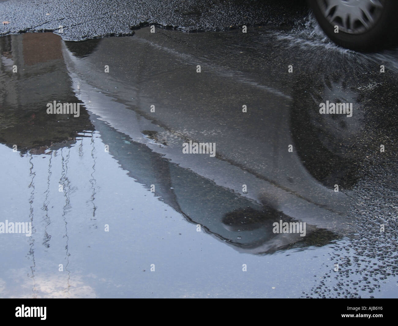 car driving through a pool of water on street Stock Photo - Alamy